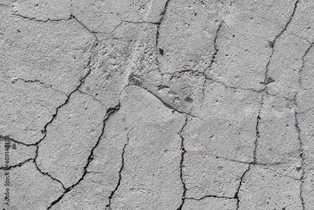 Grey texture of old broken asphalt road or wall big abrasions cracks ...