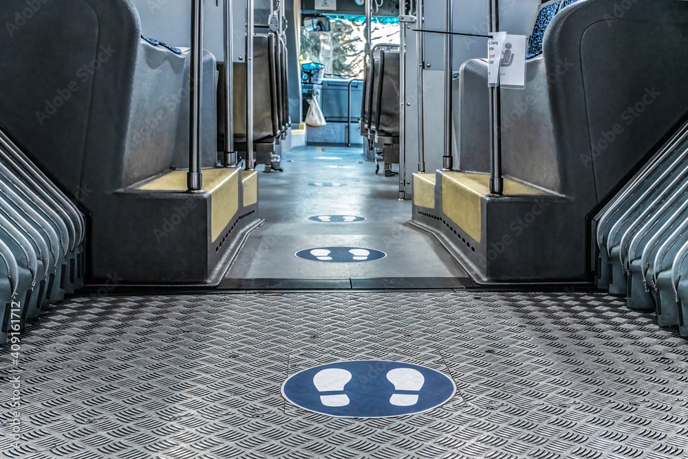 Interior of a bus showing marks on the ground to keep social distancing ...