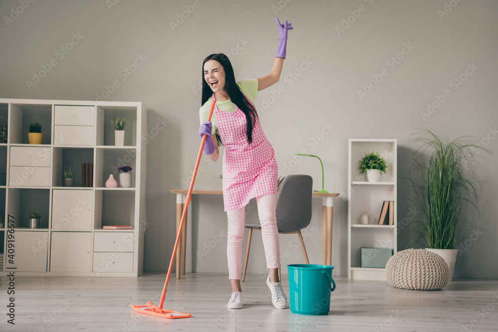 Full length body size view of pretty cheerful crazy girl maid using mop ...