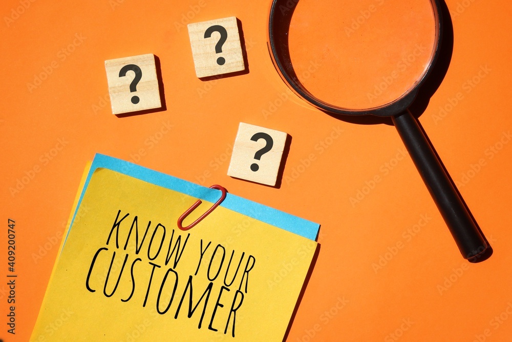 KNOW YOUR CUSTOMER text on color notepaper, wooden cube with question ...