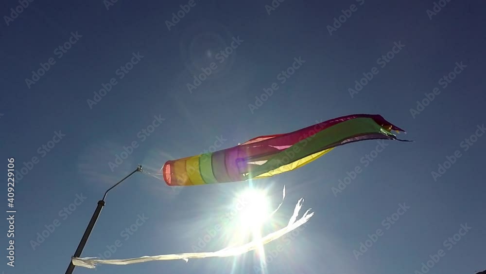 windsock for paraglider pilots in the wind against the light on a ...