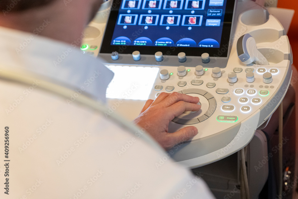 shot of a caregiver's hand, using the keyboard of an ultrasound Stock ...