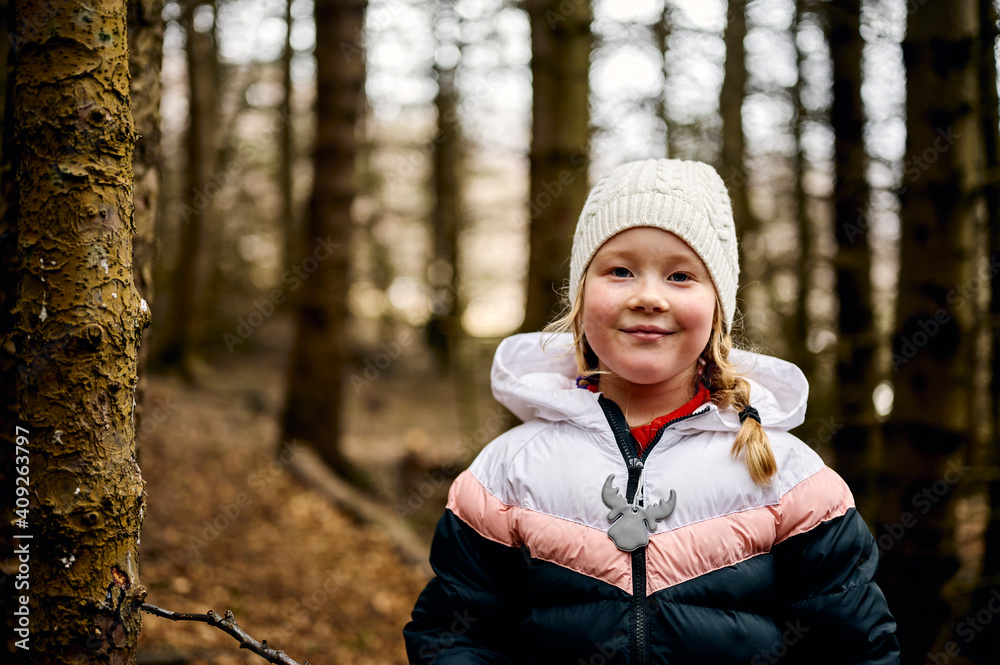 Content little girl chilling in autumn forest in daytime Stock Photo ...