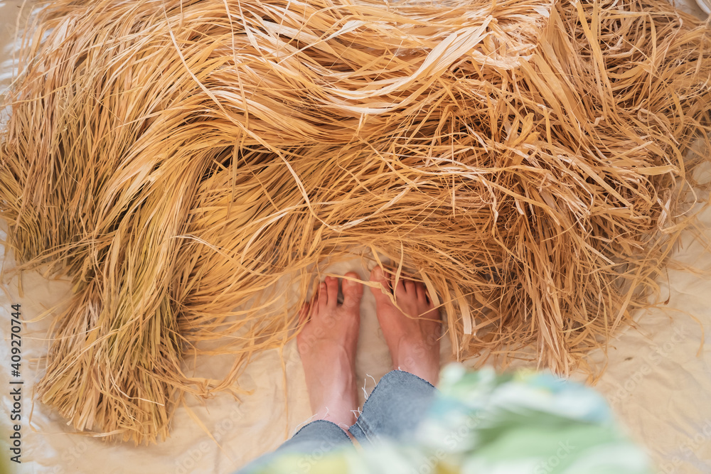 Female feet and natural palm raffia, top view. Stock Photo | Adobe Stock