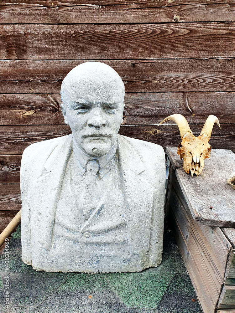 composition of a bust of V. I. Lenin and a goat skull on a box, against ...