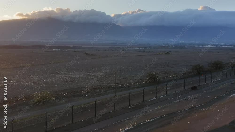 Aerial view of landfill with garbage and many plastic bags at sunset ...