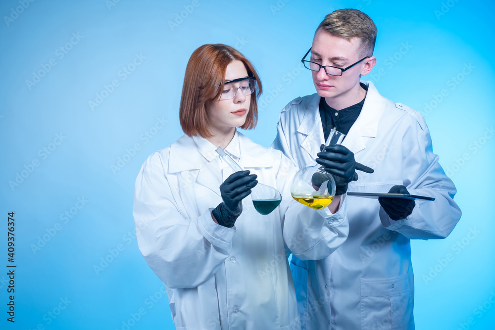 Scientific laboratory staff. Two laboratory assistants on a blue ...