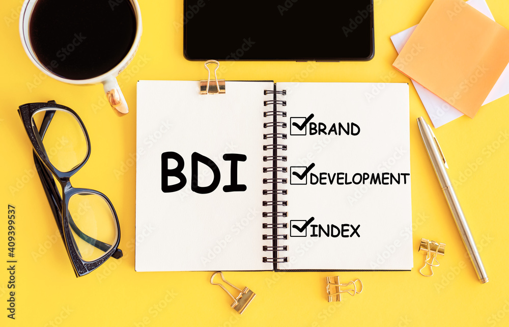 BDI - brand development index. Text on notepad and office accessories ...