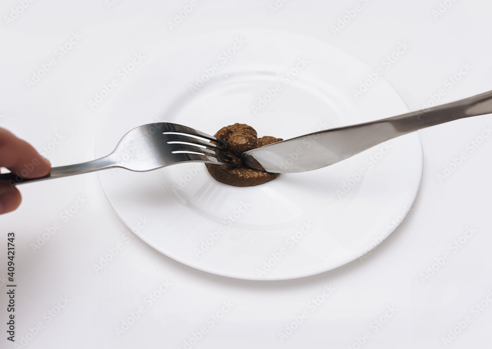 Foto de The client holds a fork and knife and cuts artificial plastic ...