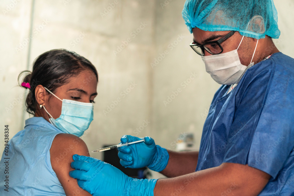 Concept of vaccination and immunization. Hospital nurse injecting a ...