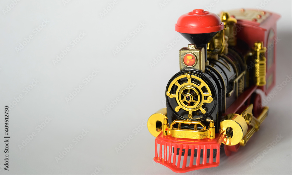 bright toy steam locomotive, red black yellow train on a white ...