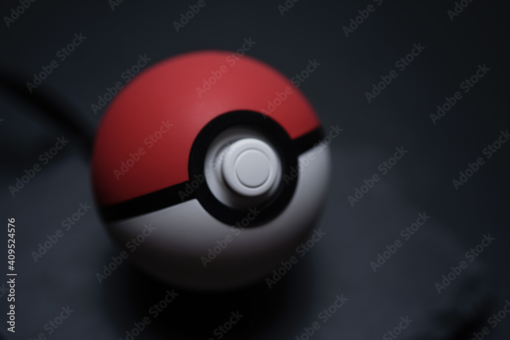 KUALA LUMPUR, MALAYSIA - JUNE 13TH, 2019 : A Poké Ball Plus on a black ...