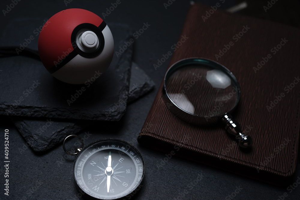 KUALA LUMPUR, MALAYSIA - JUNE 13TH, 2019 : A Poké Ball Plus on a black ...