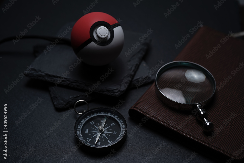 KUALA LUMPUR, MALAYSIA - JUNE 13TH, 2019 : A Poké Ball Plus on a black ...