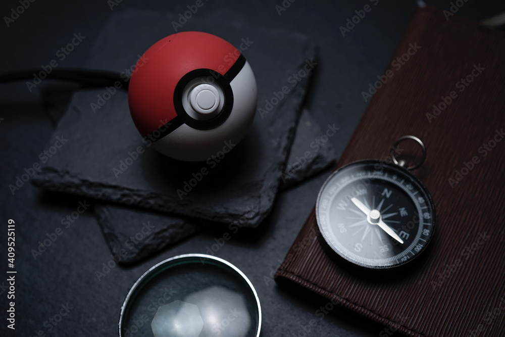 KUALA LUMPUR, MALAYSIA - JUNE 13TH, 2019 : A Poké Ball Plus on a black ...