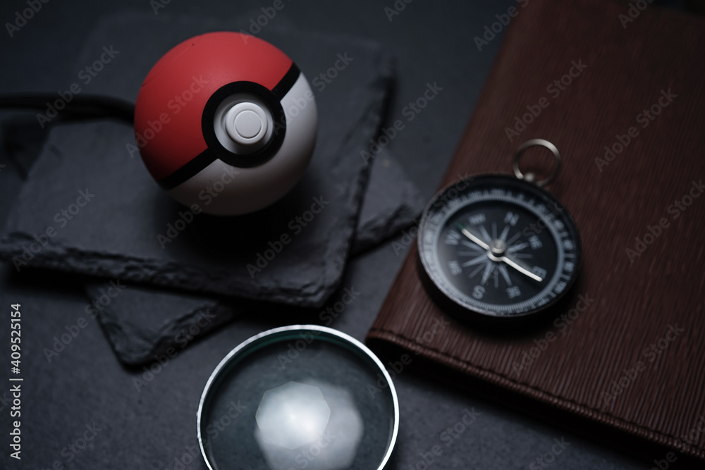 KUALA LUMPUR, MALAYSIA - JUNE 13TH, 2019 : A Poké Ball Plus on a black ...