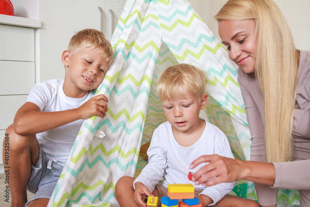 Mom and son build a tower together from constructor Stock Photo | Adobe ...