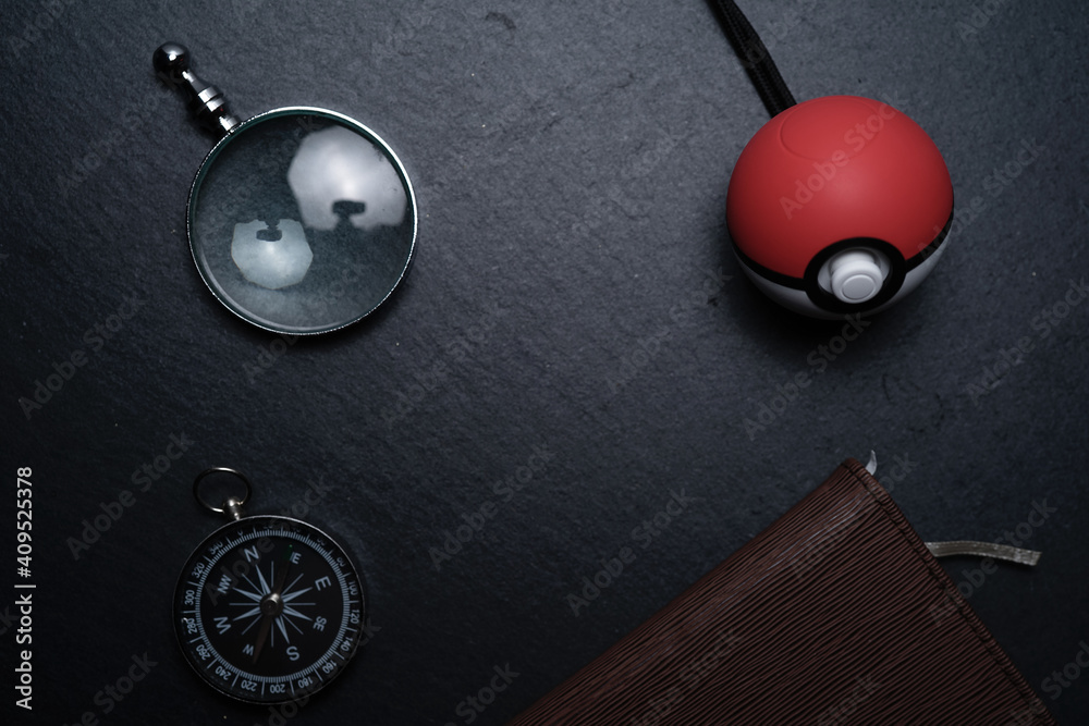 KUALA LUMPUR, MALAYSIA - JUNE 13TH, 2019 : A Poké Ball Plus on a black ...