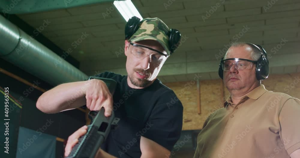 A man learns how to shoot a rifle at the shooting range. Stock ビデオ ...