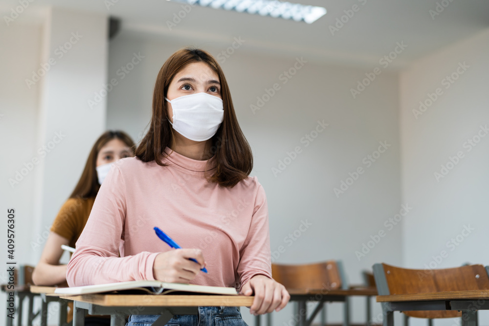 Female teenager college students wears face mask and keep distance ...