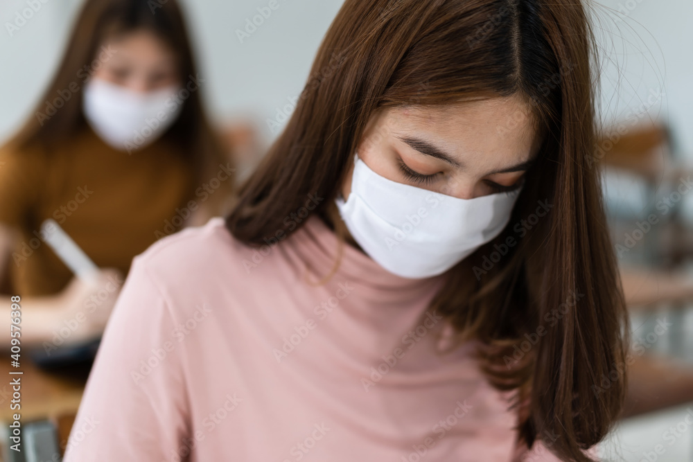 Female teenager college students wears face mask and keep distance ...