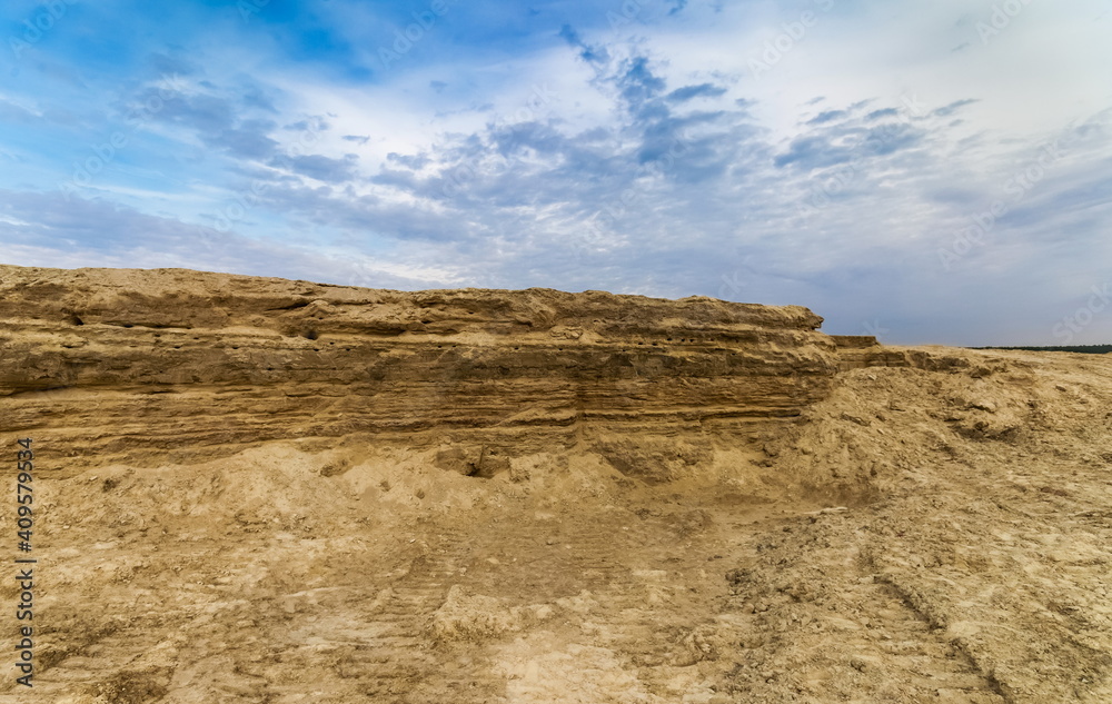 Sand ledge with holes swallows nests on the background of blue sky with ...