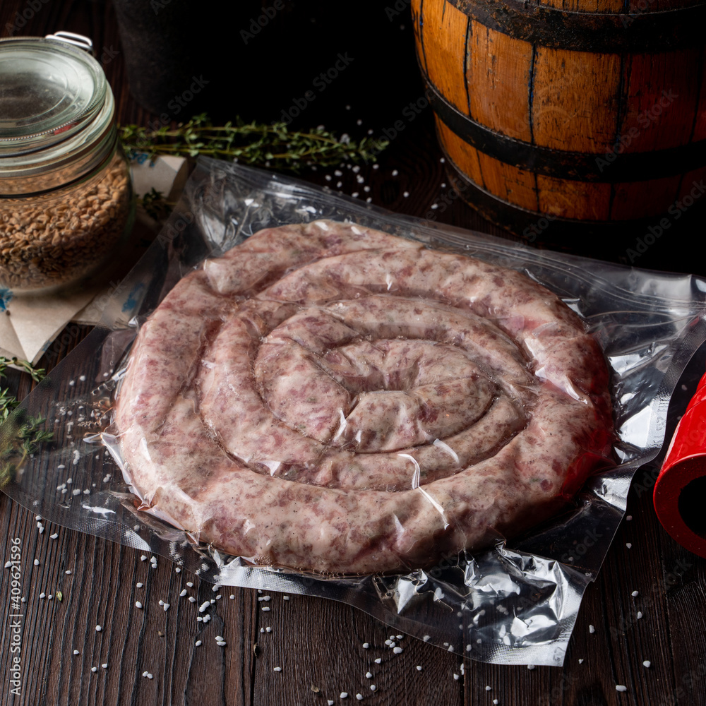 Raw twisted wurst in a vacuum packaging, food delivery during pandemic ...