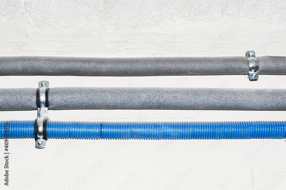 Water plumbing system background. Hot water pipes in thermal isolation ...