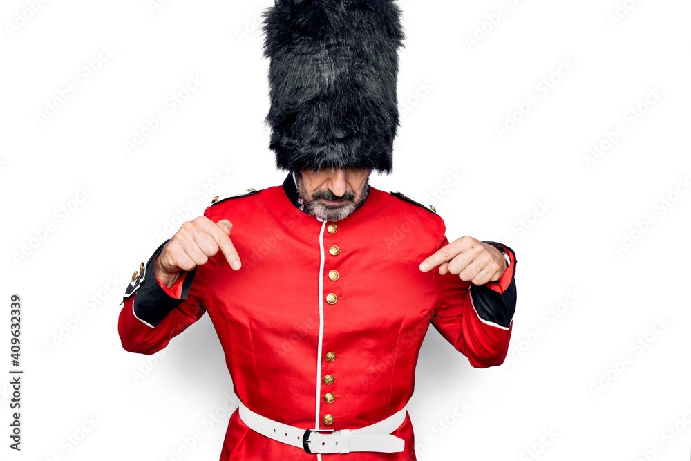 Middle age handsome wales guard man wearing traditional uniform over ...