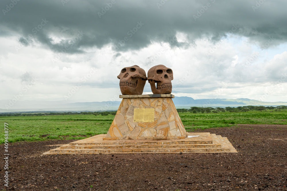 Olduvai Gorge Museum (Ngorongoro Conservation Area). Statue on the entrance. Skulls of ...