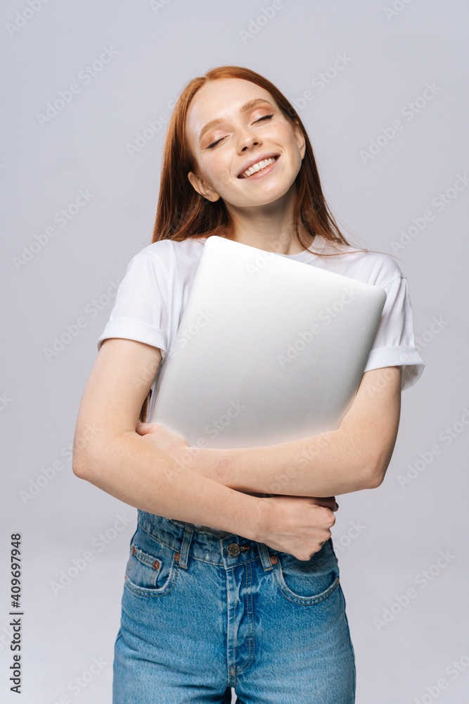 Successful young woman student holding laptop computer with closed eyes ...