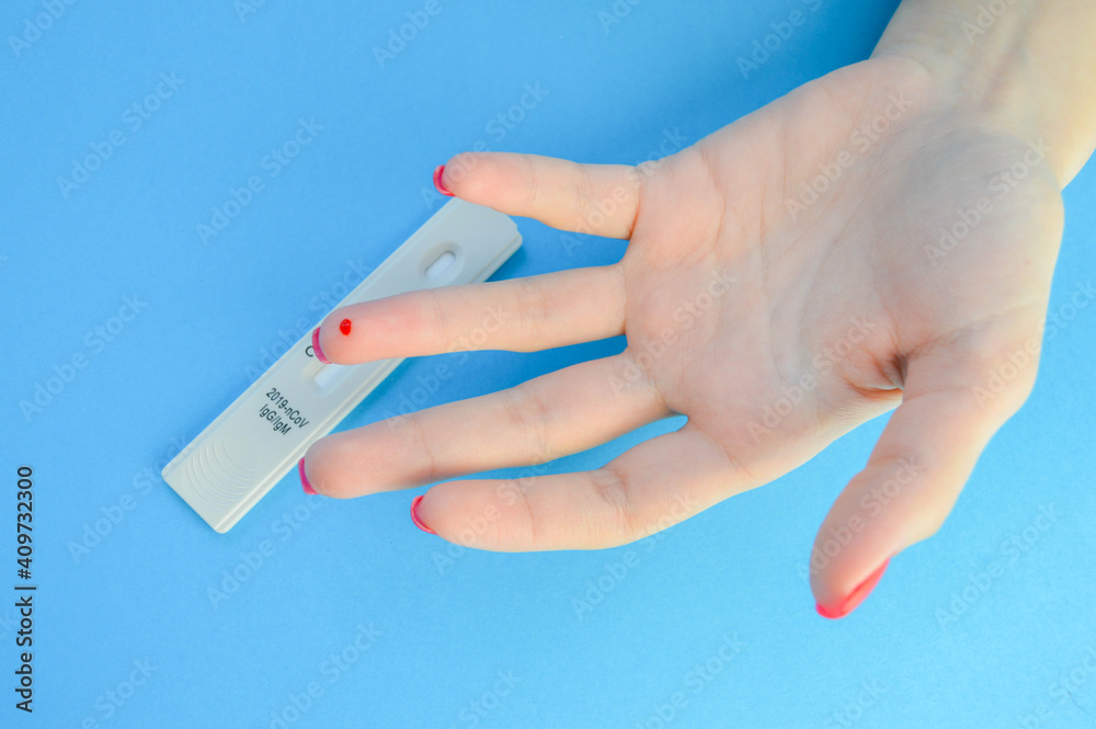 blood test for the diagnosis of coronavirus. a girl with a bright red ...