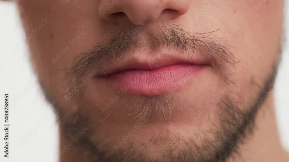 Close up facial view of male mouth, pink lips and crooked teeth on ...