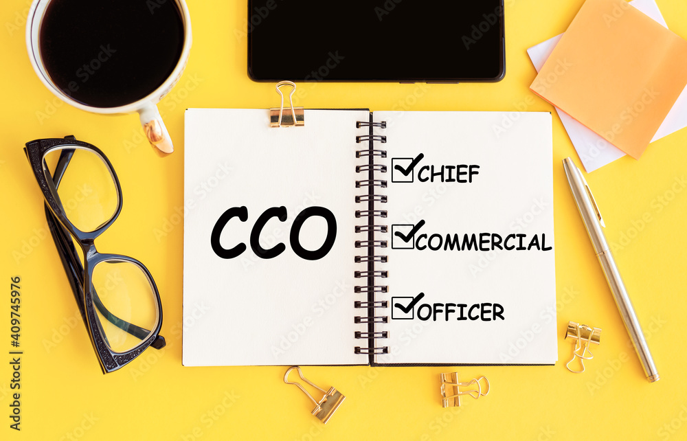 CCO - Chief Commercial officer. Text on notepad and office accessories ...