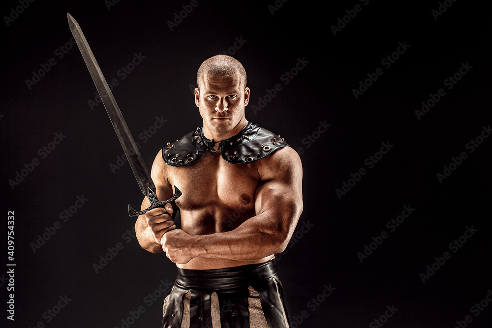 Severe barbarian in leather costume with sword. Portrait of balded ...