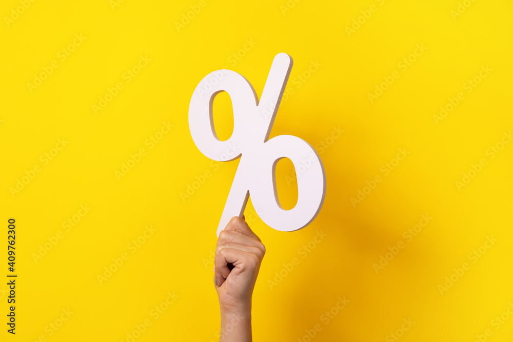 hand holding percentage sign over yellow background Stock Photo | Adobe ...