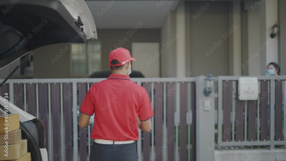 4k Video slow-motion. A male delivery worker wearing a red uniform ...