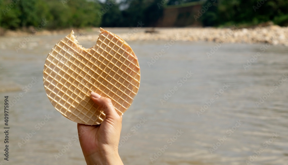 Oblea, traditional Colombian dessert, eating oblea near a river on a ...