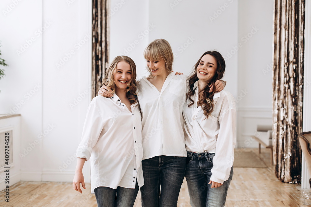 three young women hugging. Portrait of three ladies, girlfriends. 3 ...