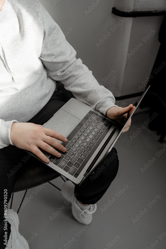 overweight man holding laptop in his hands, working in a public place ...