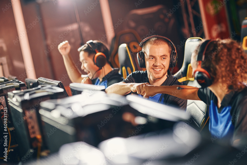 Celebrating success . Two young happy professional cyber sport gamers ...