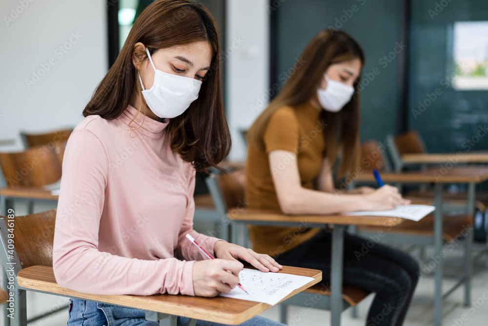Female teenager college students wears face mask and keep distance ...