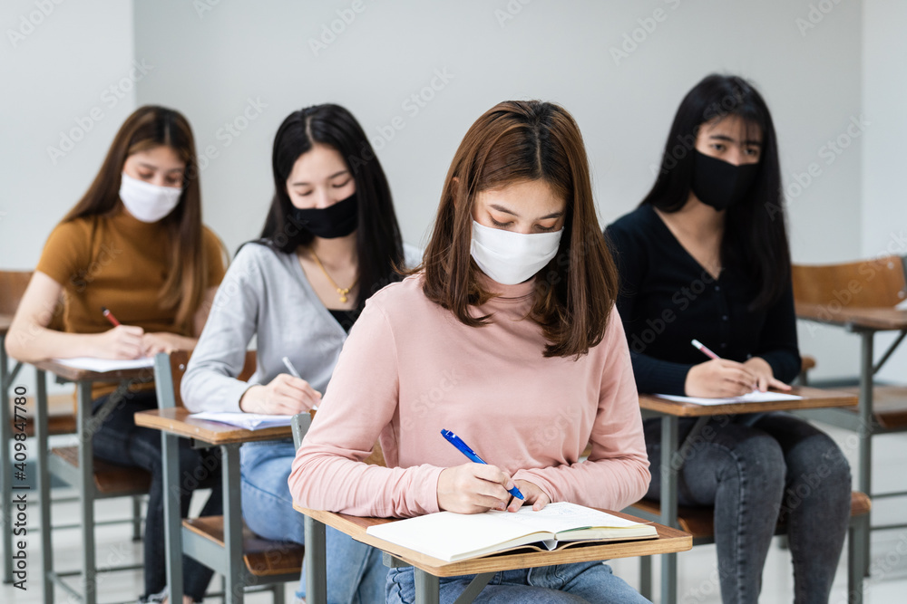 Female teenager college students wears face mask and keep distance ...