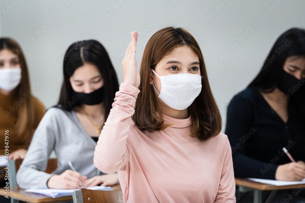 Female teenager college students wears face mask and keep distance ...