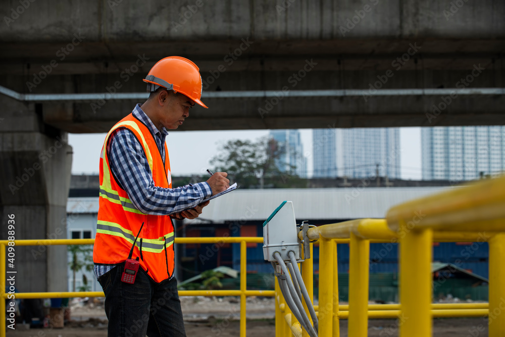 worker pushing digital meter check list. worker point to job with hand ...