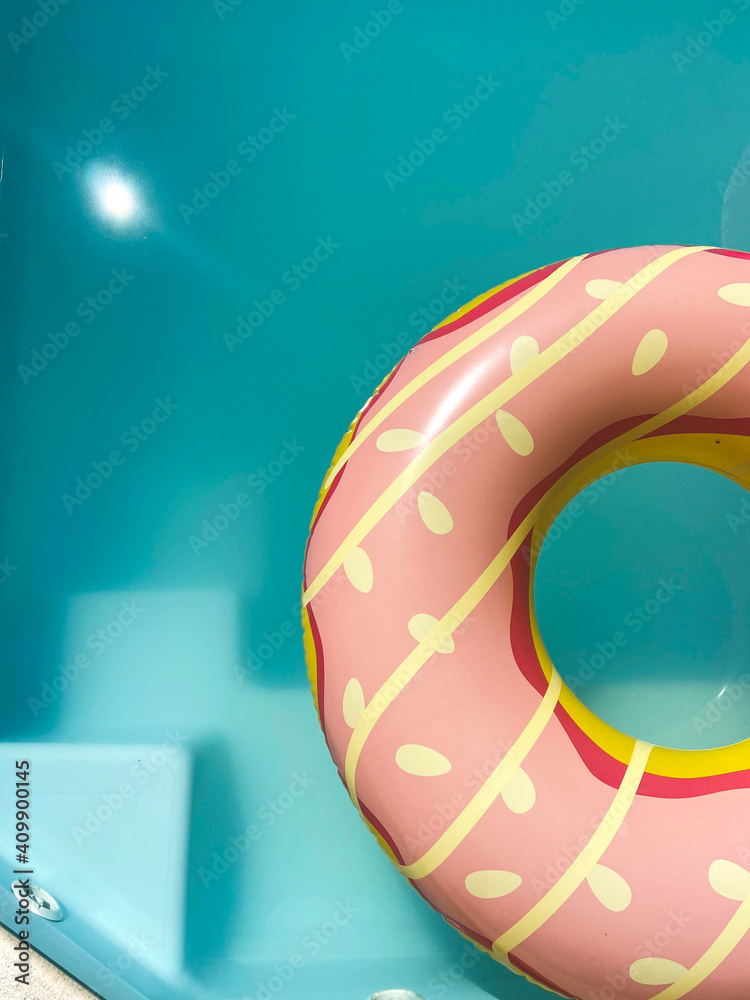 simpsons donut floating in a pool of blue water near the stairs Stock ...