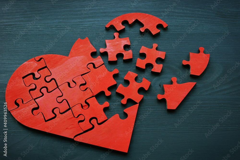 A broken heart made from puzzle pieces as a symbol of relationship ...