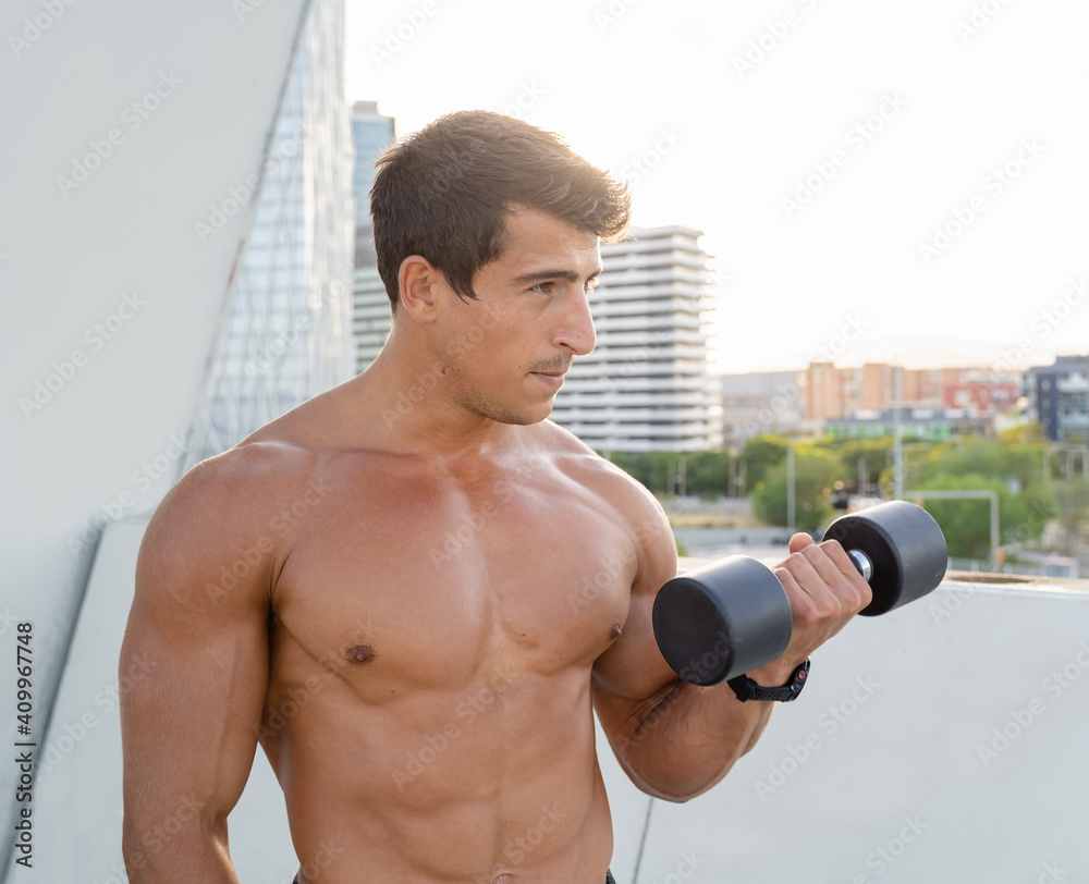 Athletic muscular shirtless guy doing fitness exercise with dumbbell ...