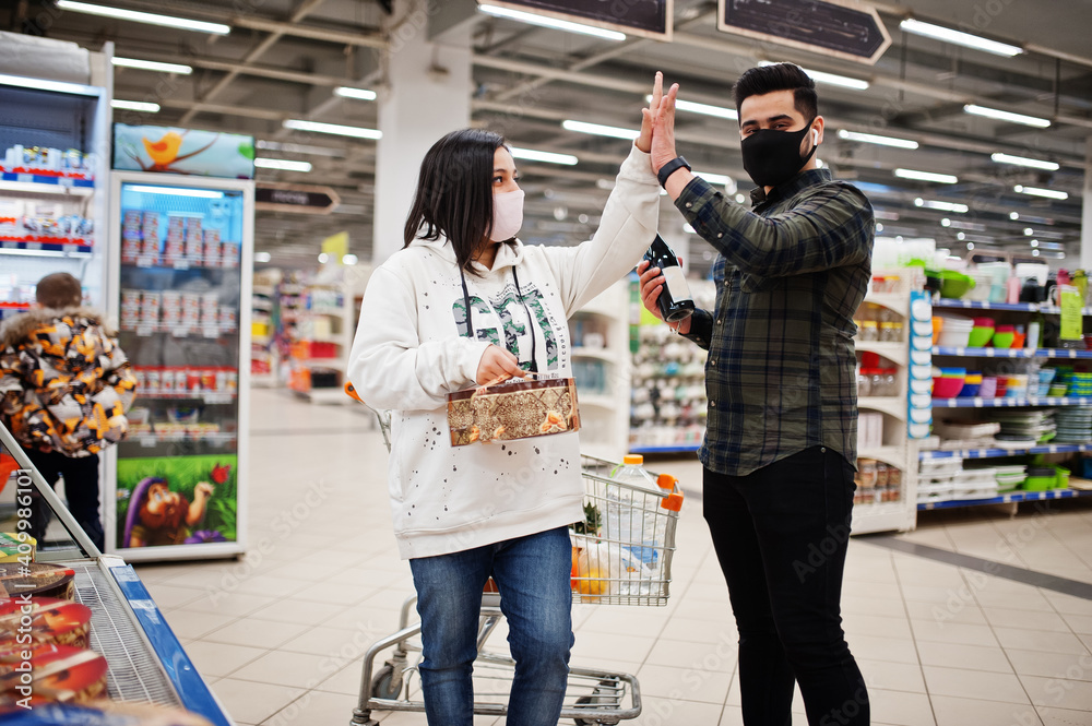 Asian couple wear in protective face mask shopping together in ...
