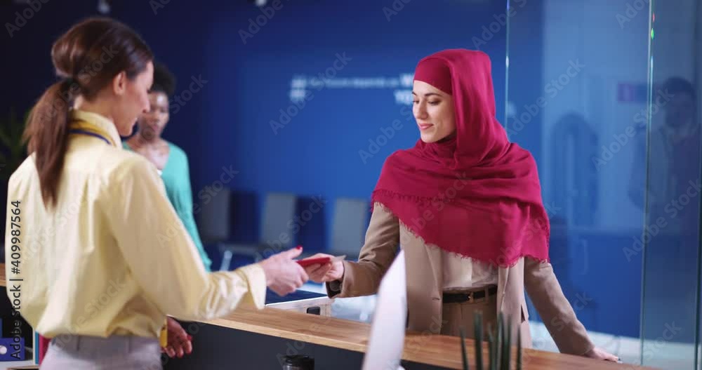 Female security agent woman standing by registration counter checking ...